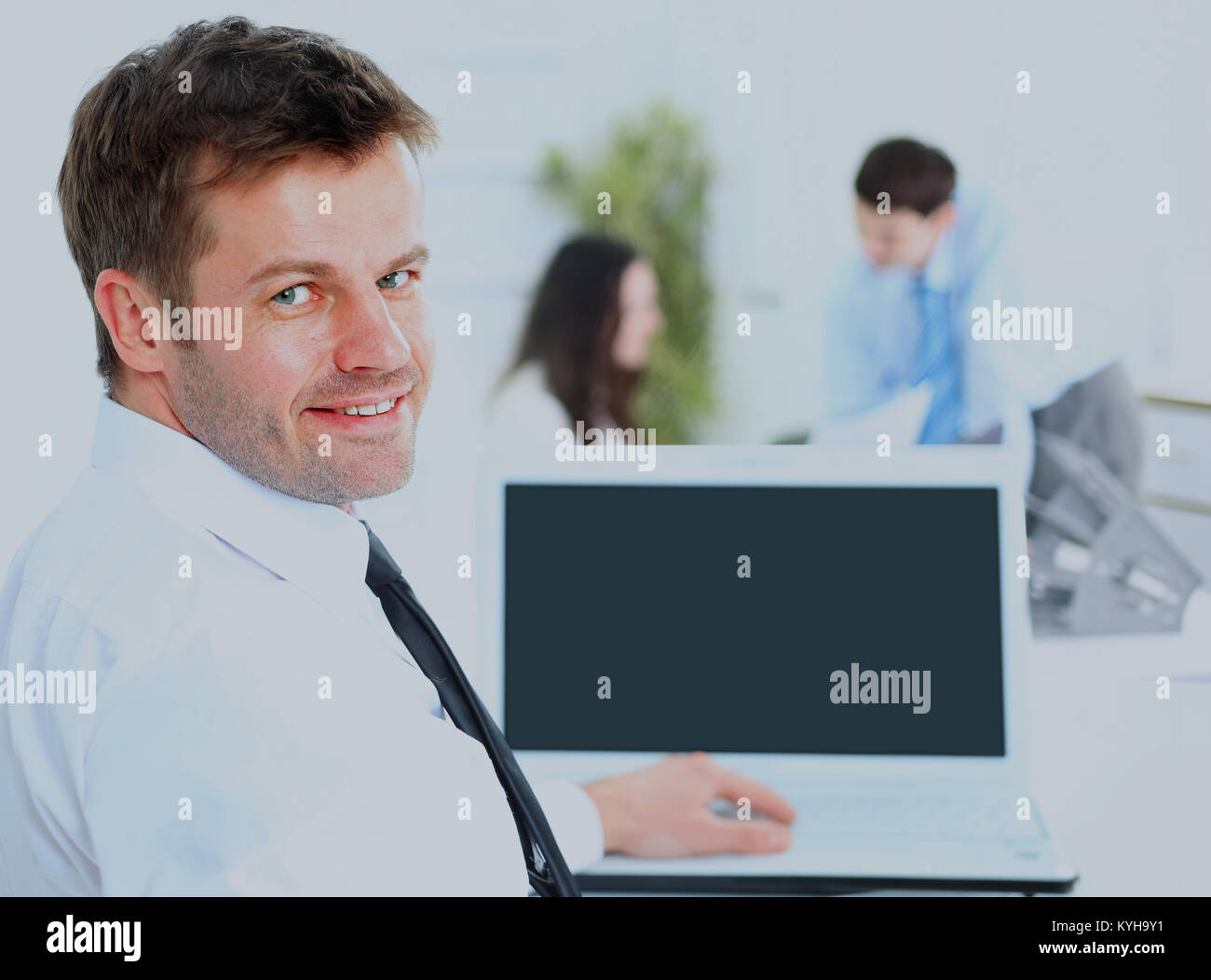 Business man sitting at his desk in the office with a laptop Stock ...