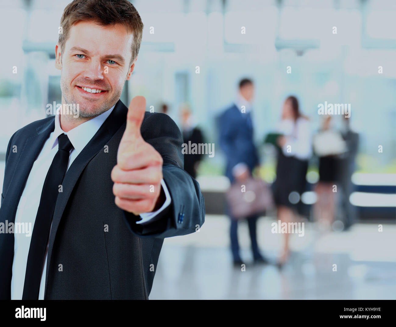 Businessman showing OK sign with his thumb up. Selective focus on face ...