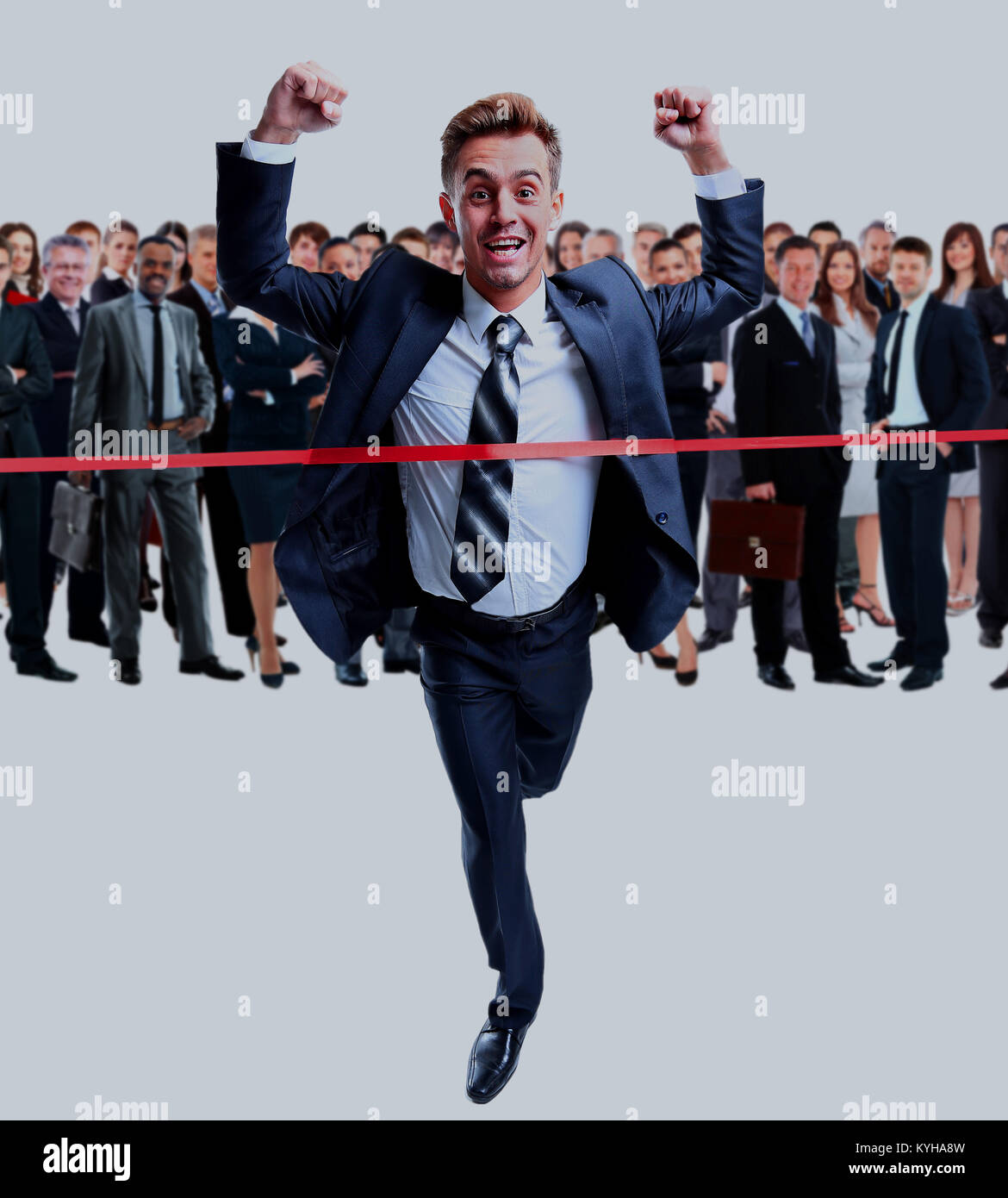 Happy businessman running through finishing line Stock Photo - Alamy