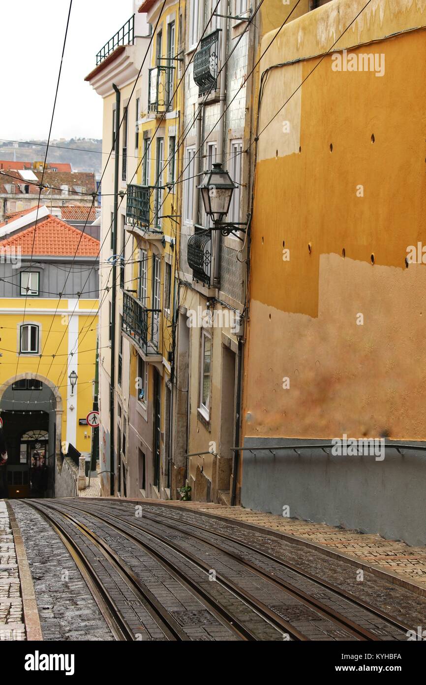 Inclined street in Lisbon and Bica Elevator rails Stock Photo - Alamy