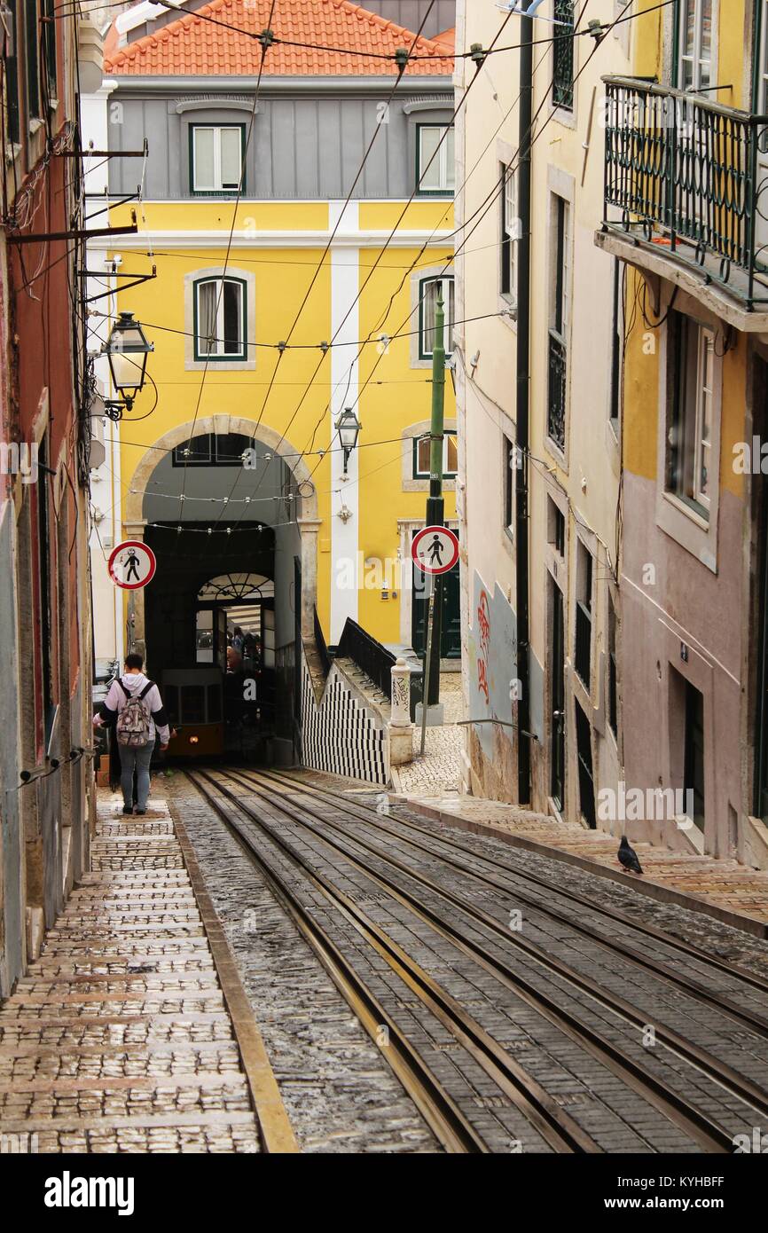 Inclined street in Lisbon and Bica Elevator rails Stock Photo - Alamy