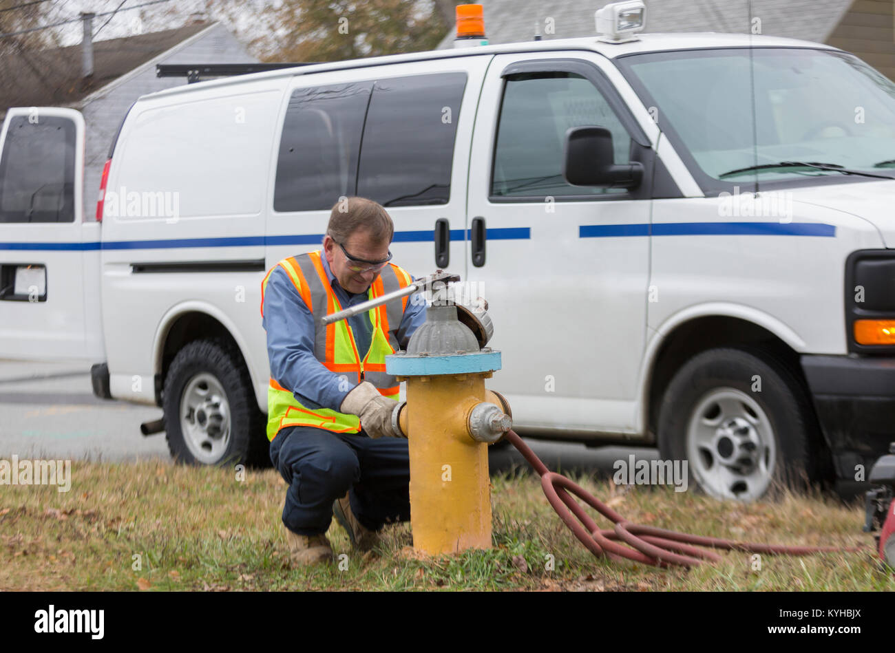 Water department technician reinstalling caps on fire hydrant Stock ...