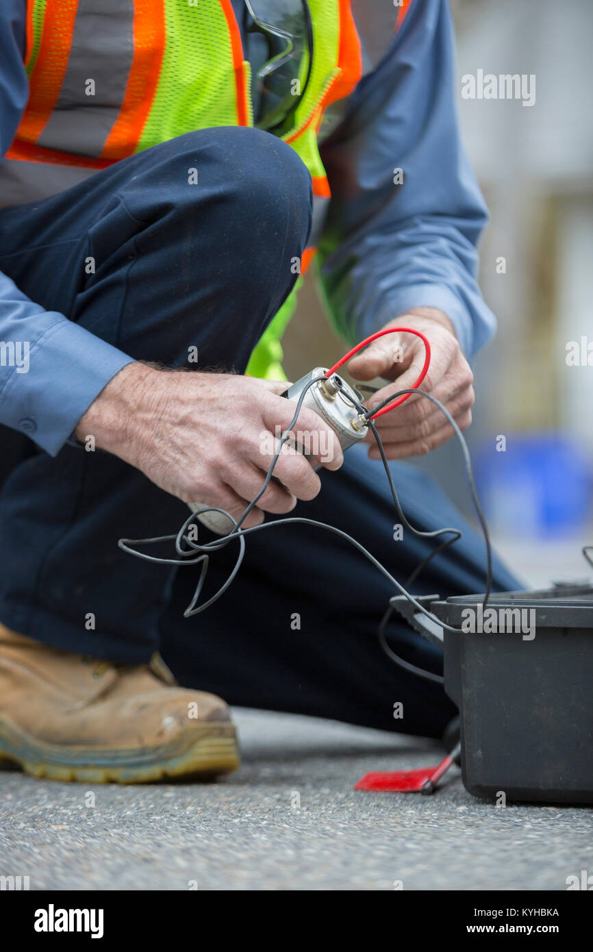 Water department technician using flow rate sensor Stock Photo - Alamy