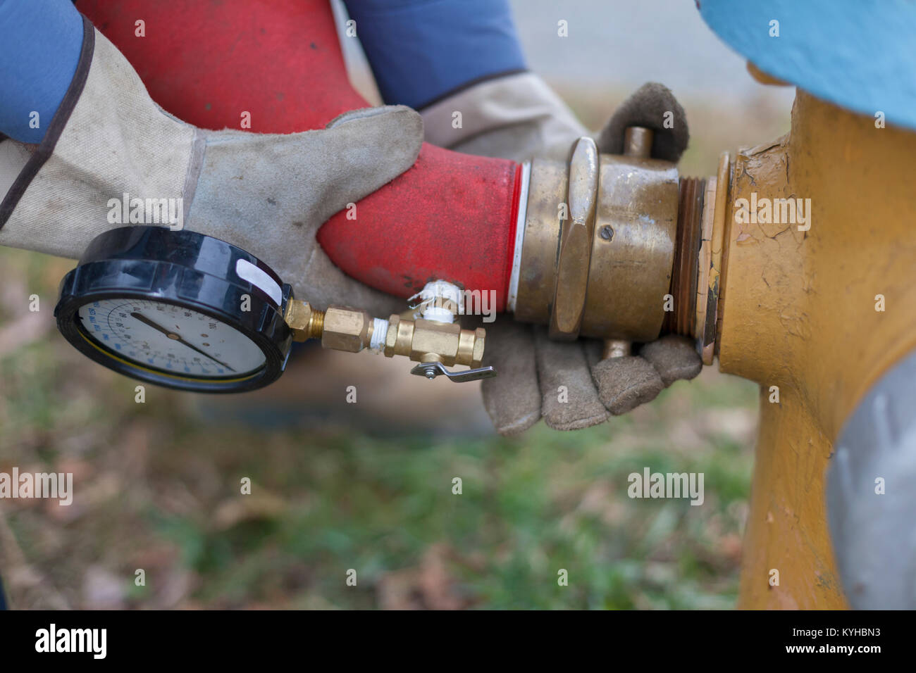Technician installing hydrant attachment with sensor for flushing mains ...