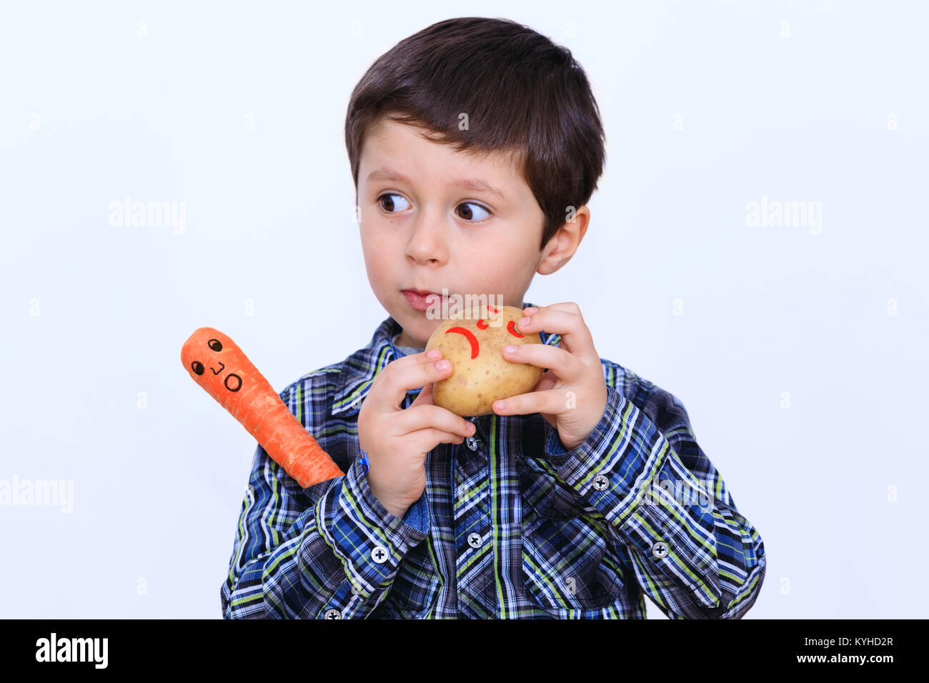Cute boy intrigued by the feelings of vegetables Stock Photo - Alamy