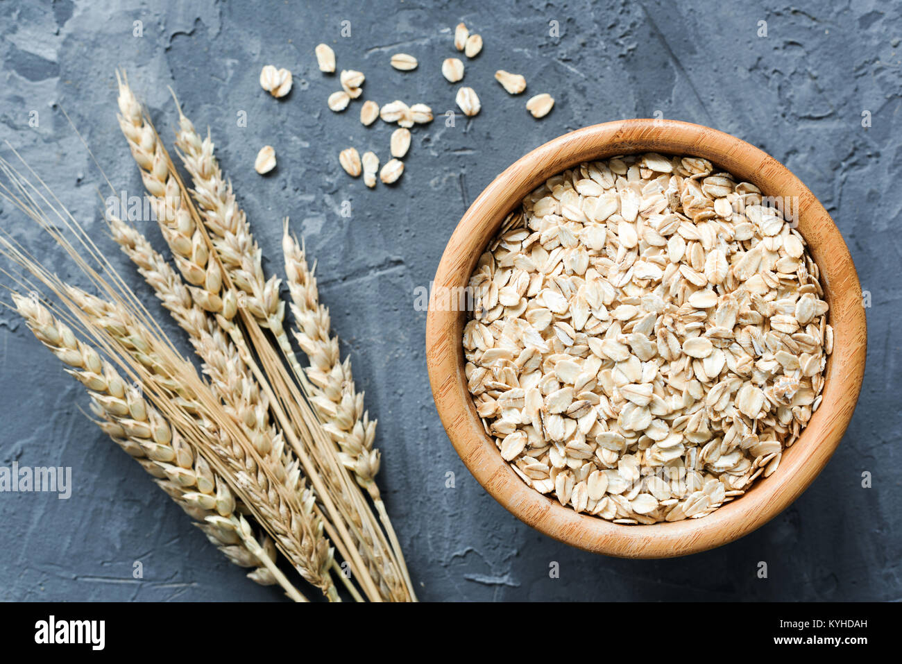 Oats in wooden bowl. Uncooked rolled oats. Oat flakes. Top view ...