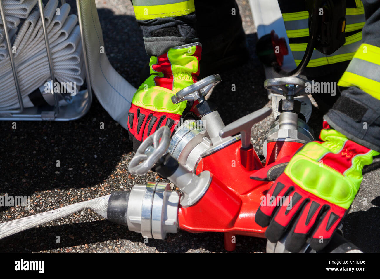 german fireman with gloves handles a water dispenser Stock Photo - Alamy