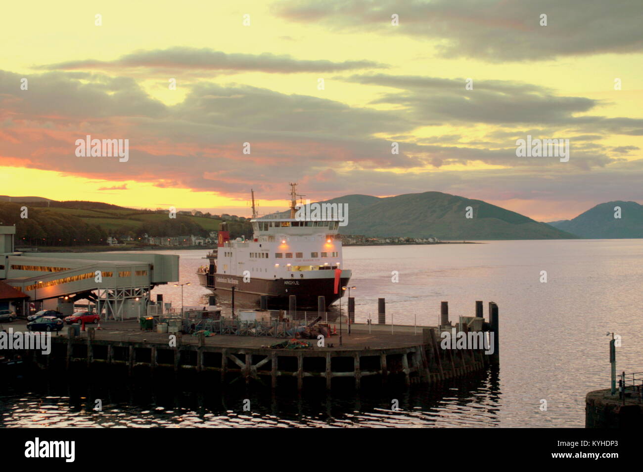 sunset night shot of Rothesay harbour with the ferry argyle docking for ...