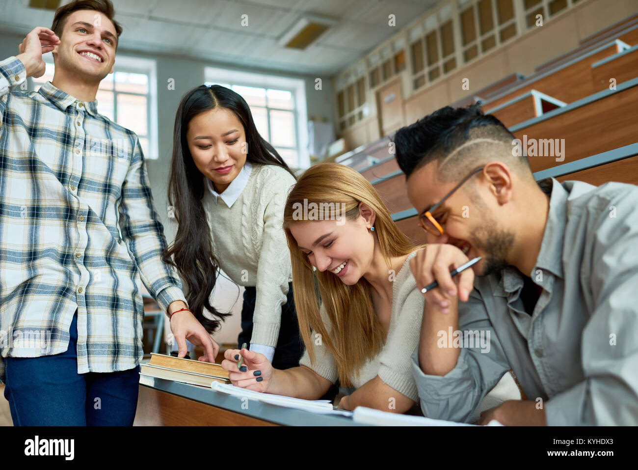 Multi-ethnic group of students having fun and laughing in lecture hall ...