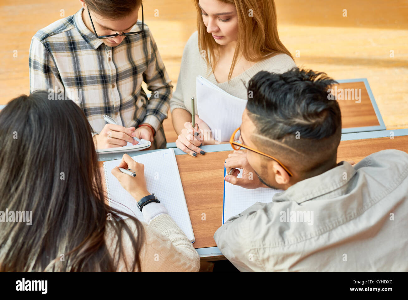 Multi-ethnic group of students studying together in lecture hall of ...
