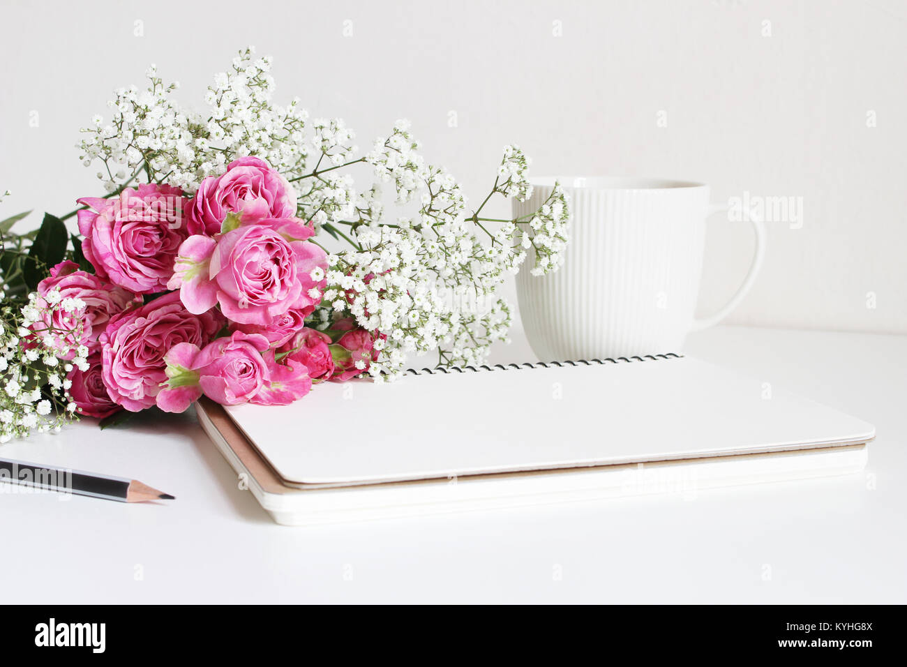 Wedding styled stock photo. Still life with pink roses, baby's breath Gypsophila flowers, white ...