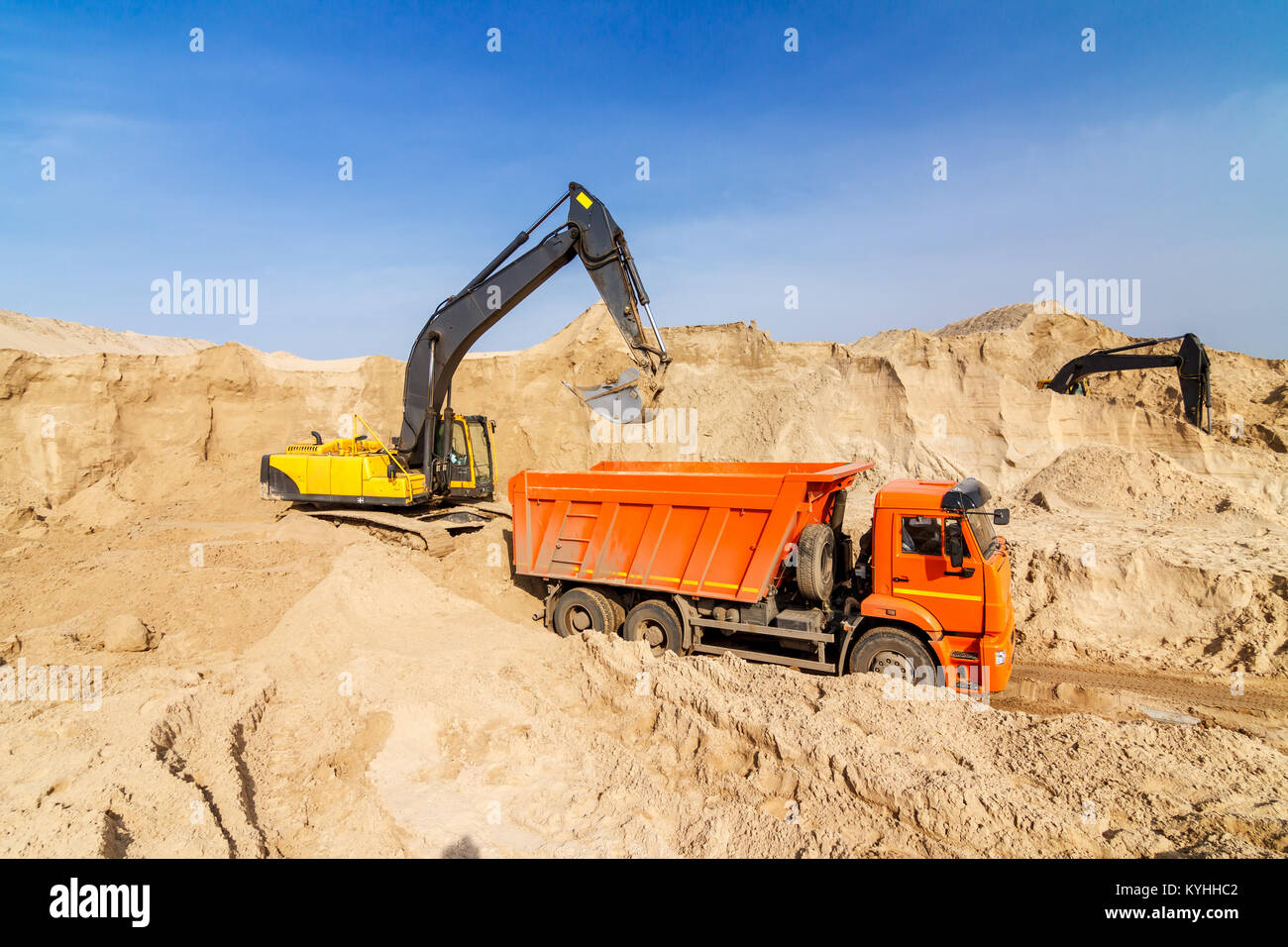 Excavator Loading Dumper Truck at Construction Site Stock Photo - Alamy