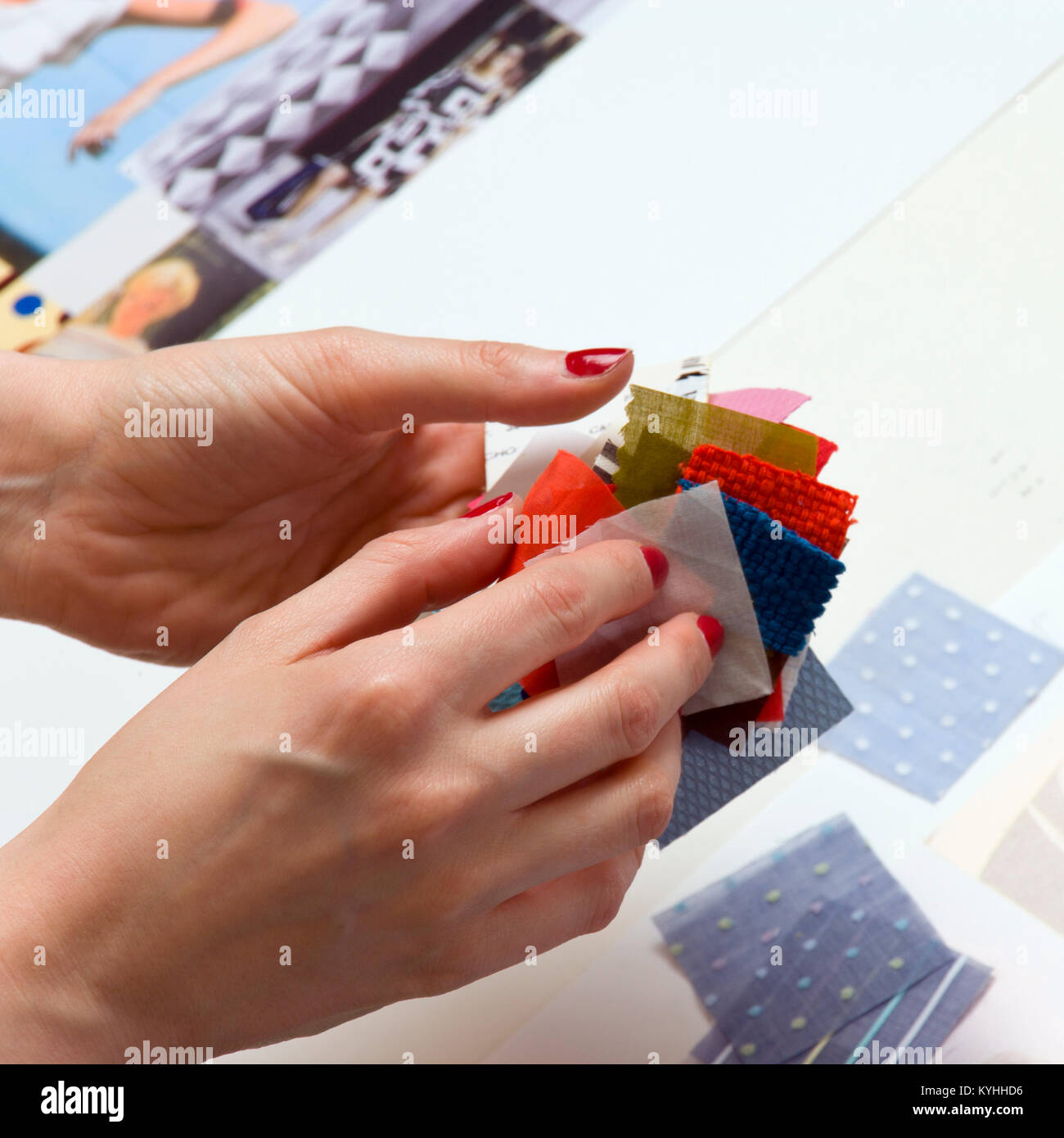 A womans hand holding a selection of coloured fabric swatches Stock ...