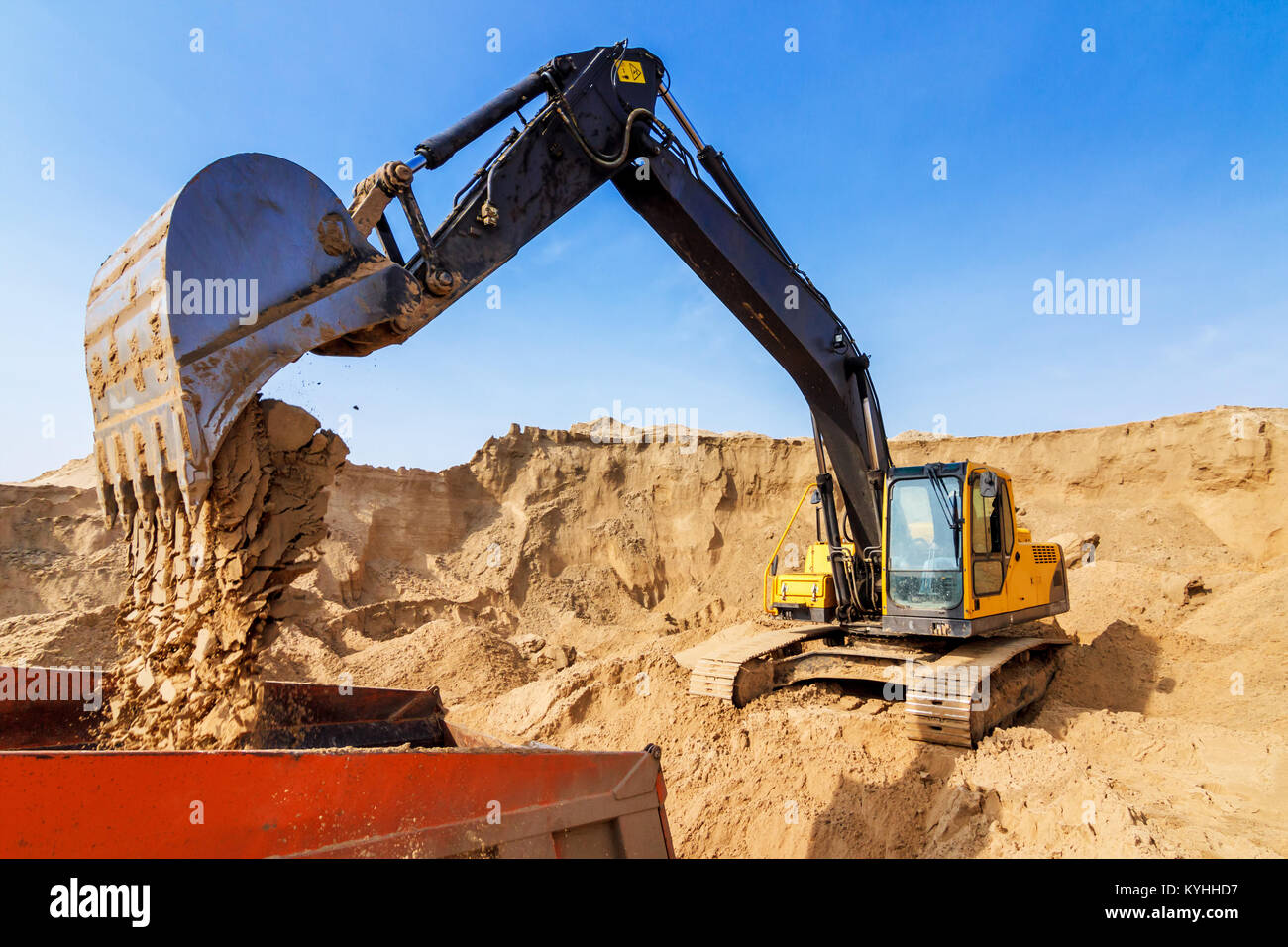 Excavator Loading Dumper Truck at Construction Site Stock Photo - Alamy