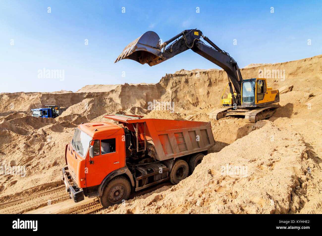 Excavator Loading Dumper Truck at Construction Site Stock Photo - Alamy