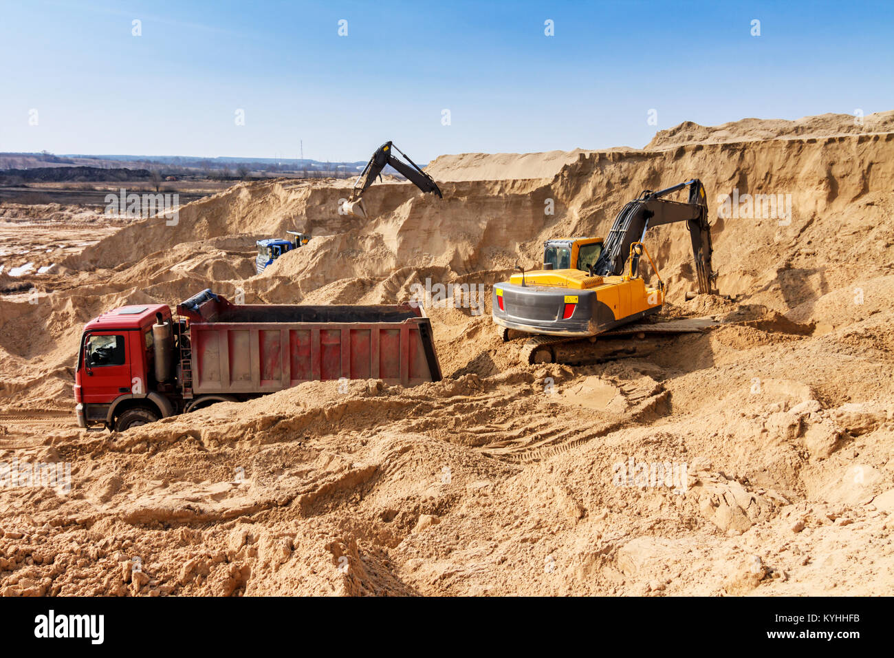 Excavator Loading Dumper Truck at Construction Site Stock Photo - Alamy