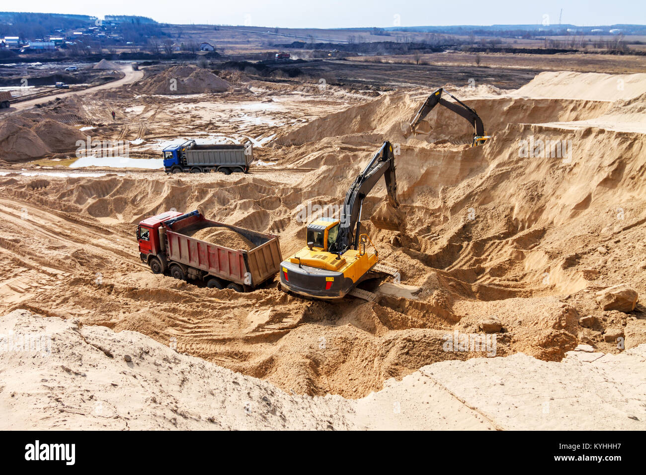 Excavator Loading Dumper Truck at Construction Site Stock Photo - Alamy