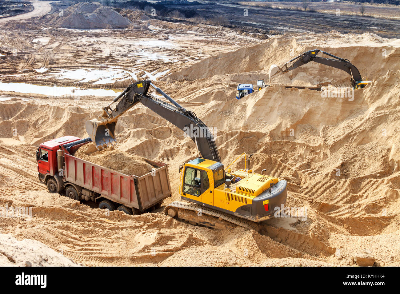 Excavator Loading Dumper Truck at Construction Site Stock Photo - Alamy