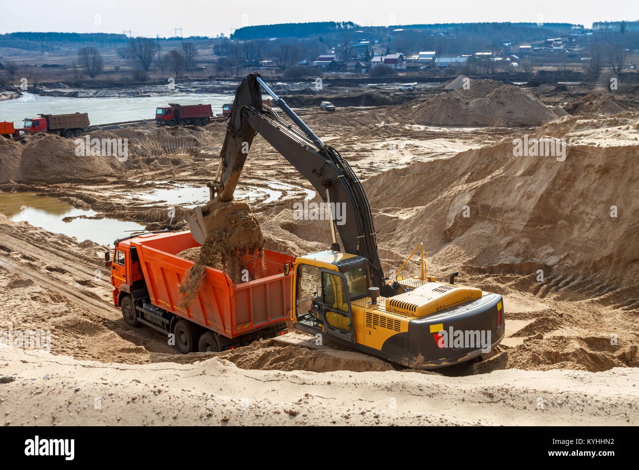 Excavator Loading Dumper Truck at Construction Site Stock Photo - Alamy