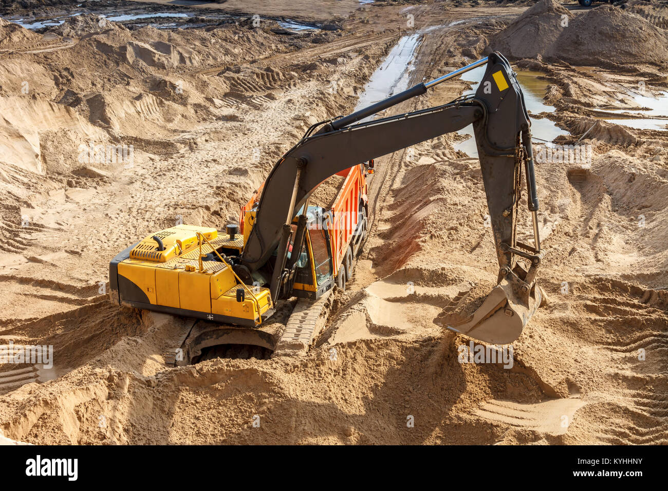 Excavator Loading Dumper Truck at Construction Site Stock Photo - Alamy