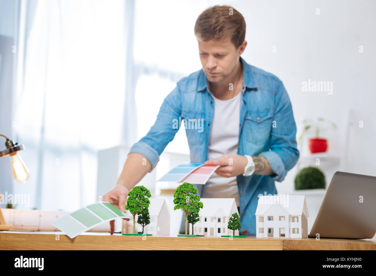 Concentrated worker trying to choose the best color for a house Stock ...