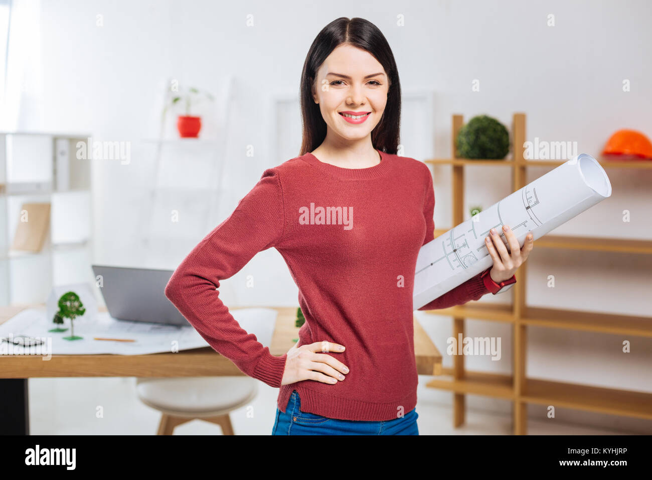 Enthusiastic engineer standing with a ready drawing and smiling Stock ...