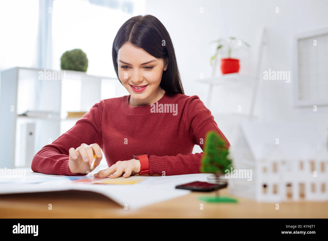Clever person smiling and thinking about the project Stock Photo - Alamy