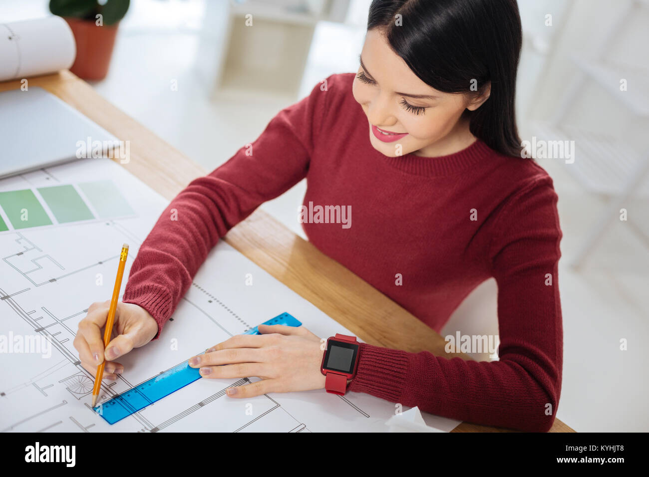 Responsible engineer sitting and drawing the lines on her scheme Stock ...