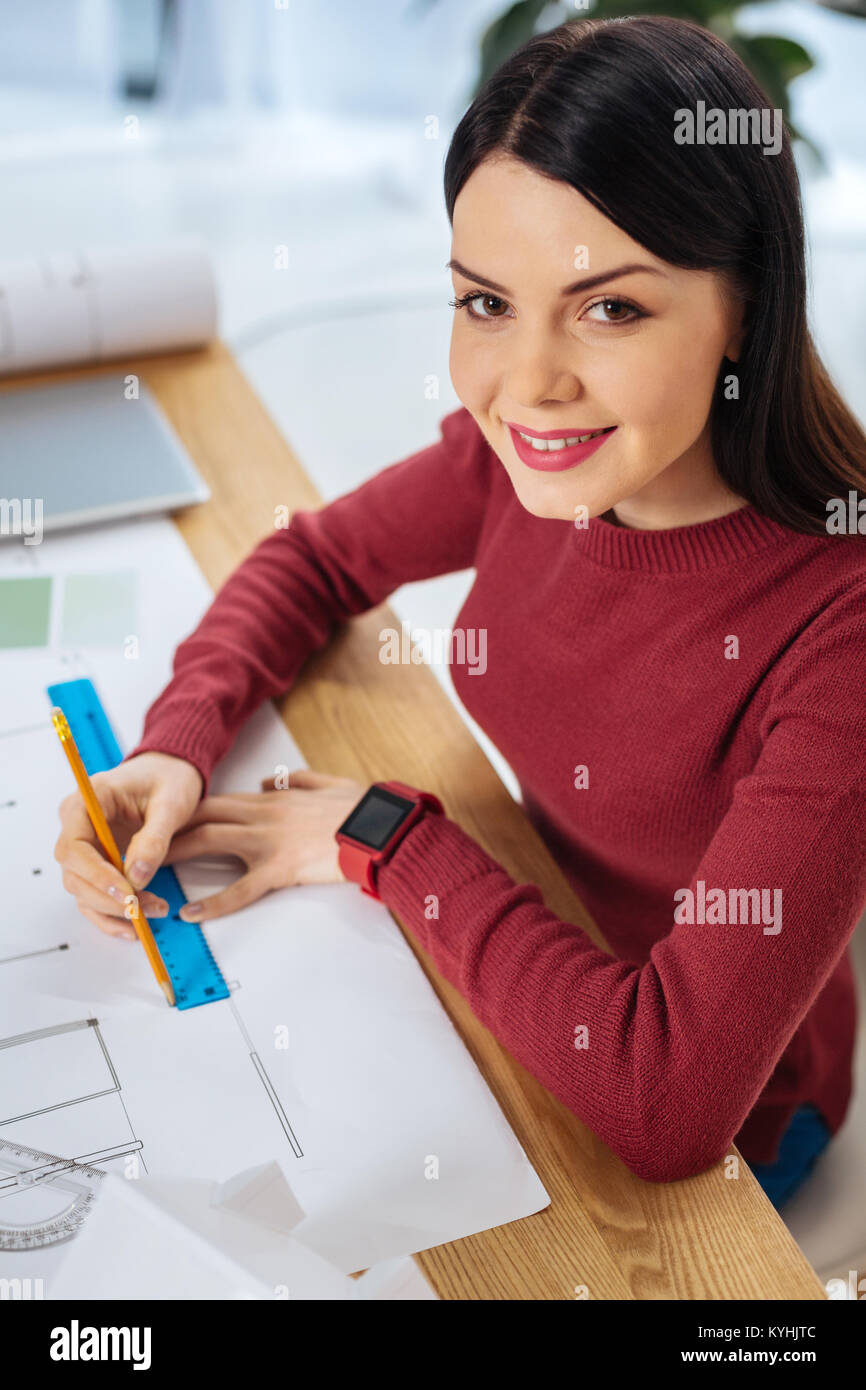 Smiling person finishing her work and feeling happy Stock Photo - Alamy