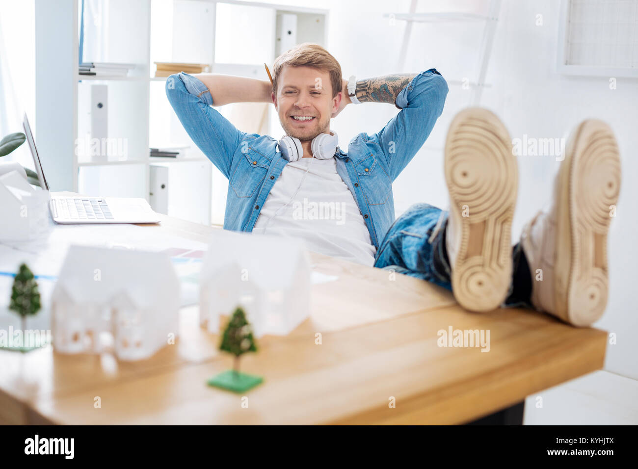 Happy engineer putting his feet on the table and relaxing Stock Photo ...