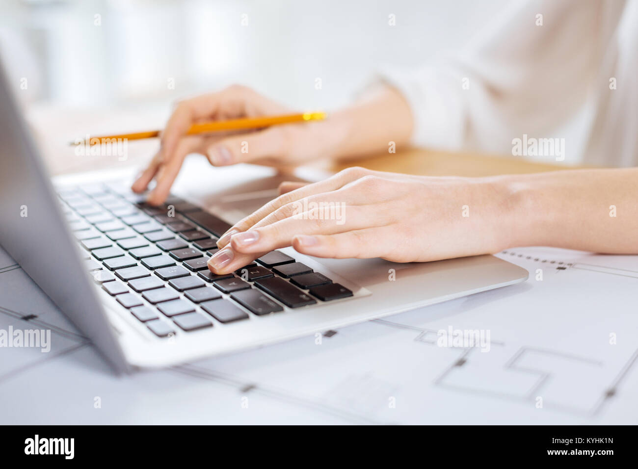 Calm worker typing a text while being in the office Stock Photo - Alamy