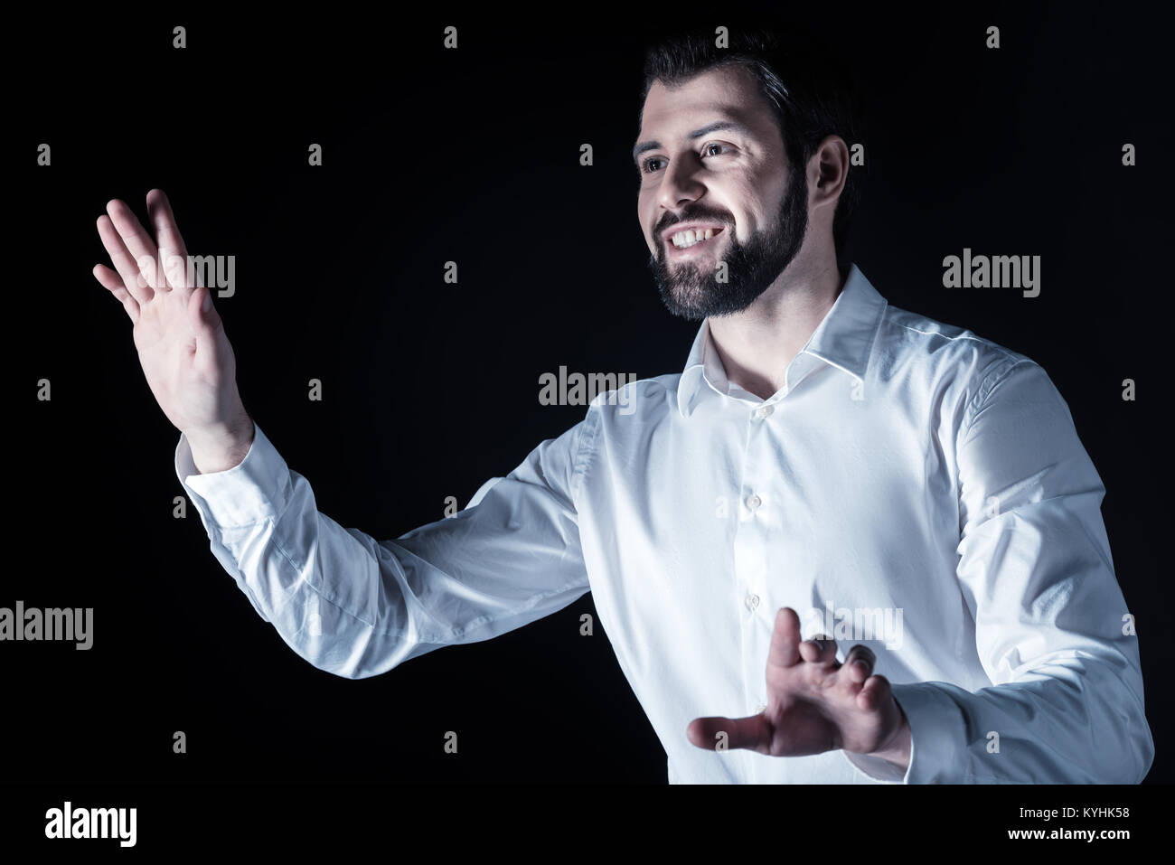 Positive cheerful man looking at the invisible screen Stock Photo - Alamy