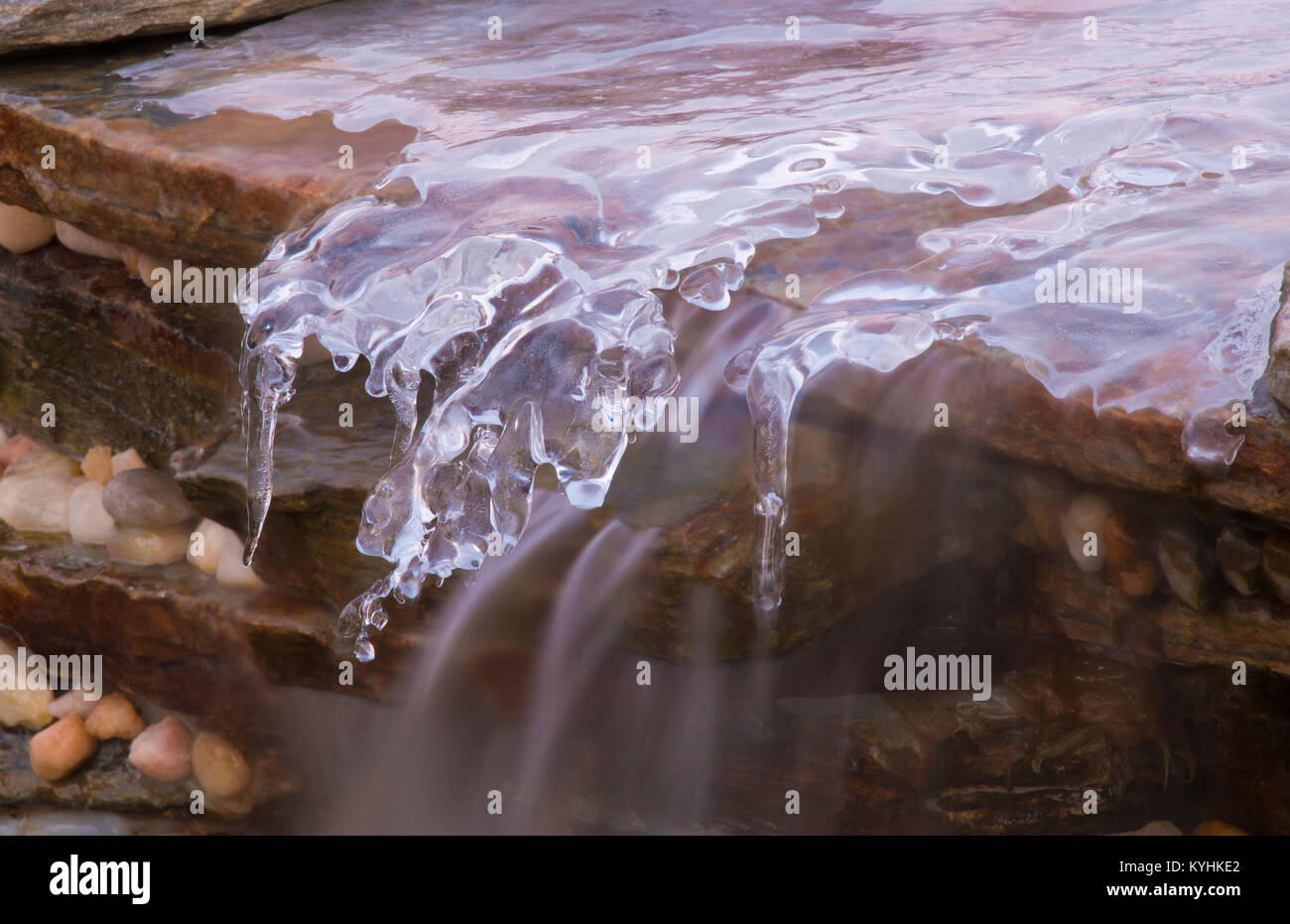 Small cascade with ice and icicles with water still flowing Stock Photo ...