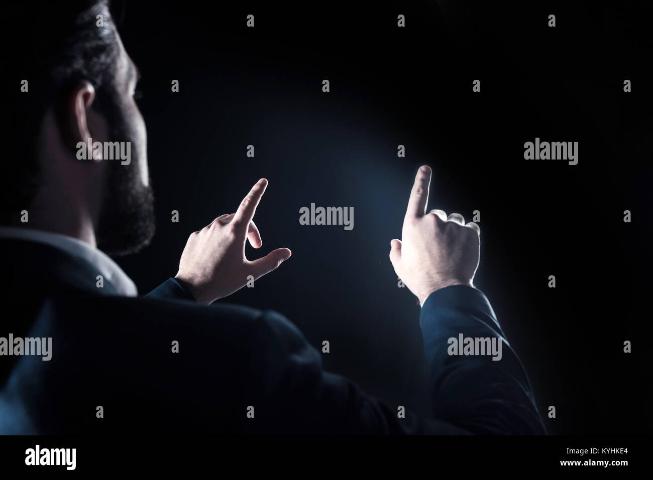Nice smart businessman looking at his fingers Stock Photo - Alamy