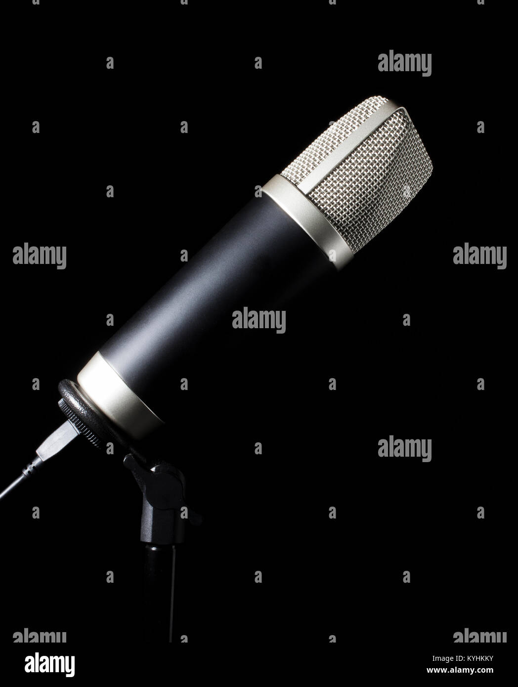 Black background behind a microphone with wire mesh head Stock Photo ...