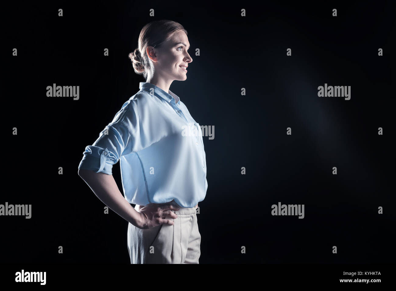 Joyful pleasant woman standing half face Stock Photo - Alamy