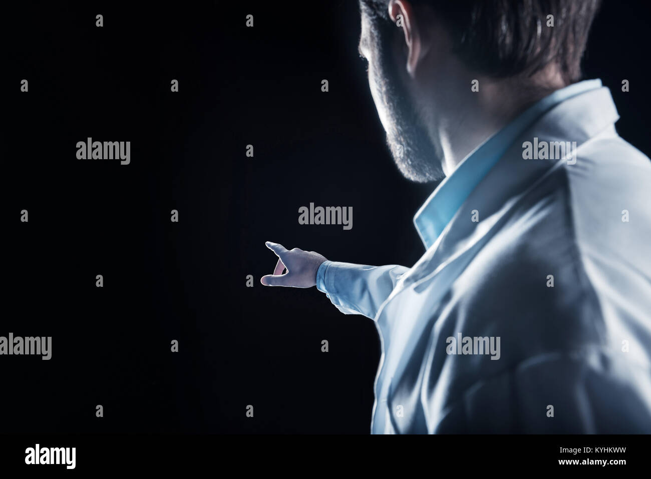 Intelligent pleasant man looking at his hand Stock Photo - Alamy