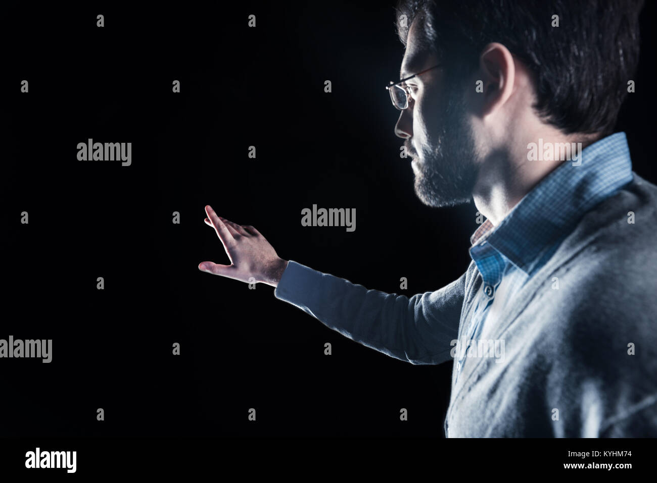 Smart pleasant man looking at his hand Stock Photo - Alamy