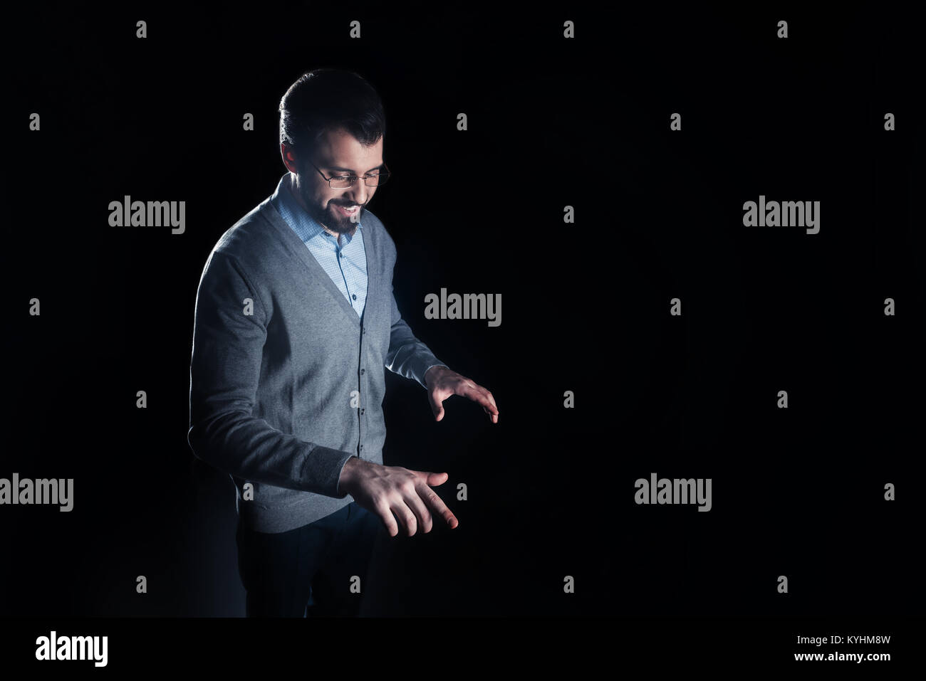 Joyful positive man using transparent device Stock Photo - Alamy