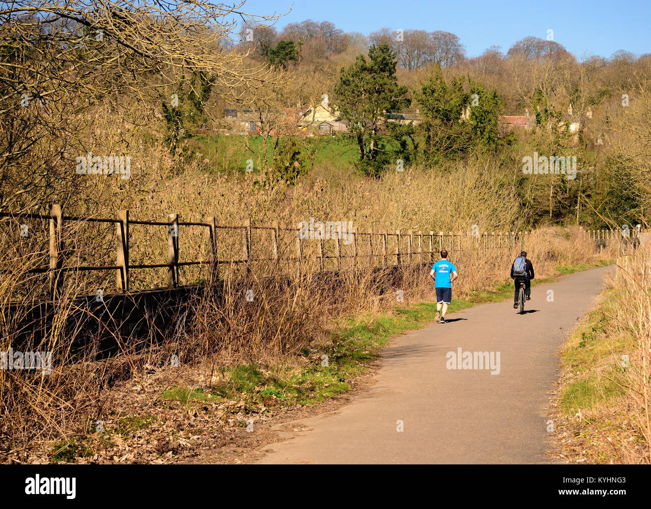 A cyclist and jogger crossing the deck of Midford viaduct that once ...