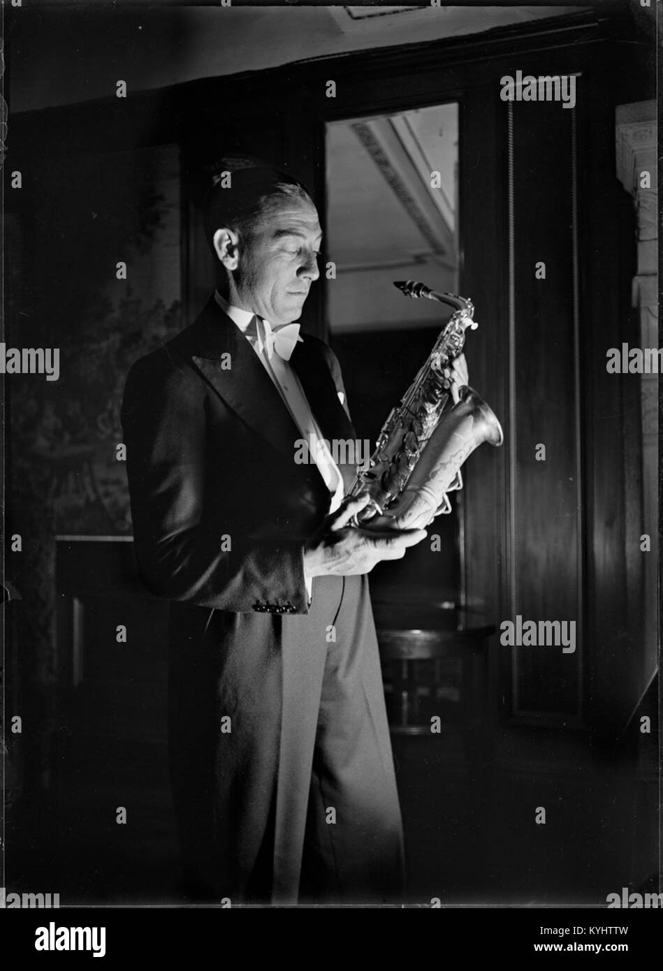 A photograph of Sam Babicci holding a saxophone, capturing his ...