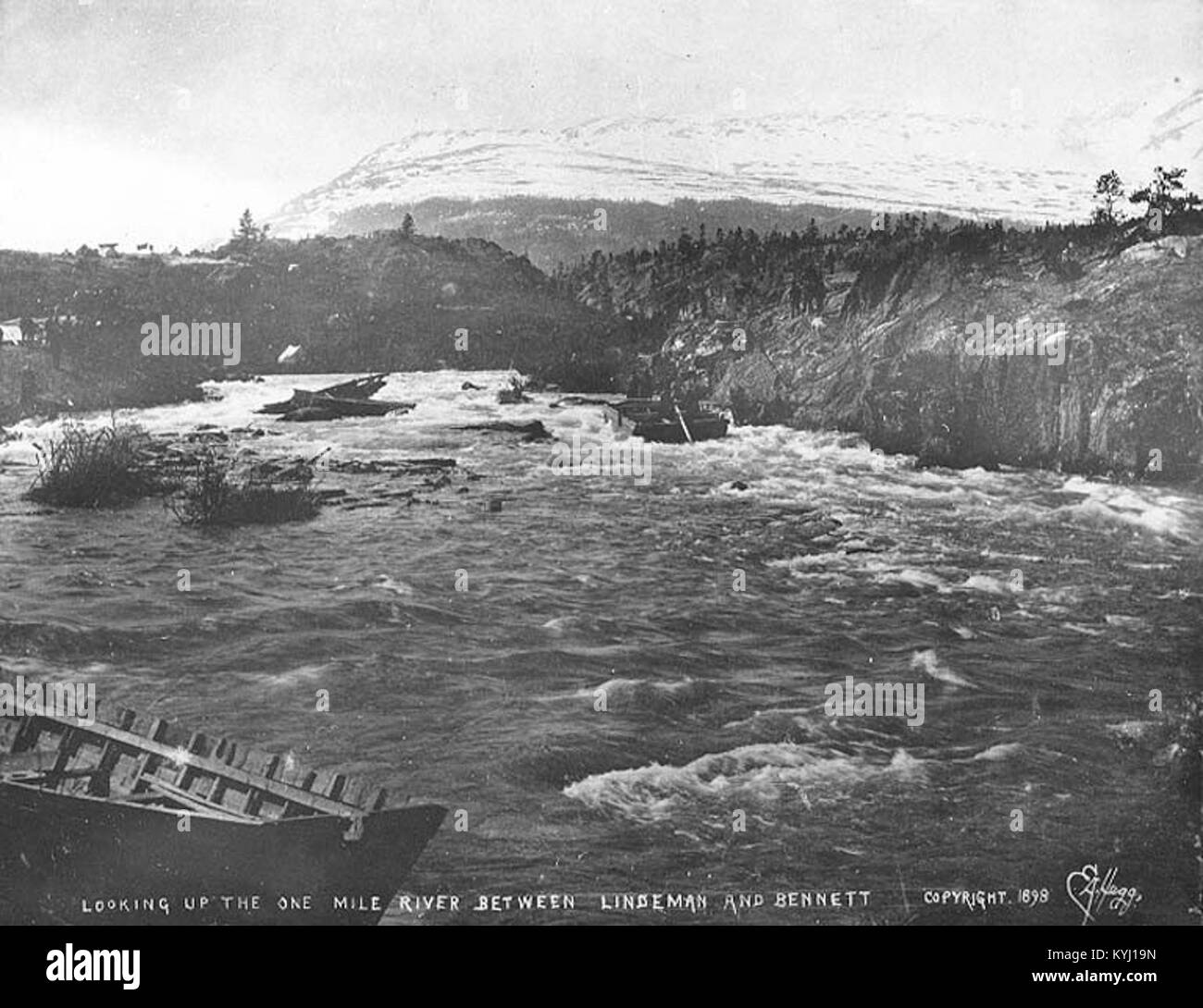 A 1898 photograph showing a scow boat navigating One Mile River in ...