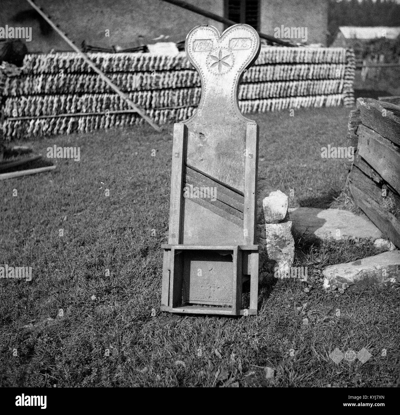 A historical photograph of a traditional fishnet weaving machine ...