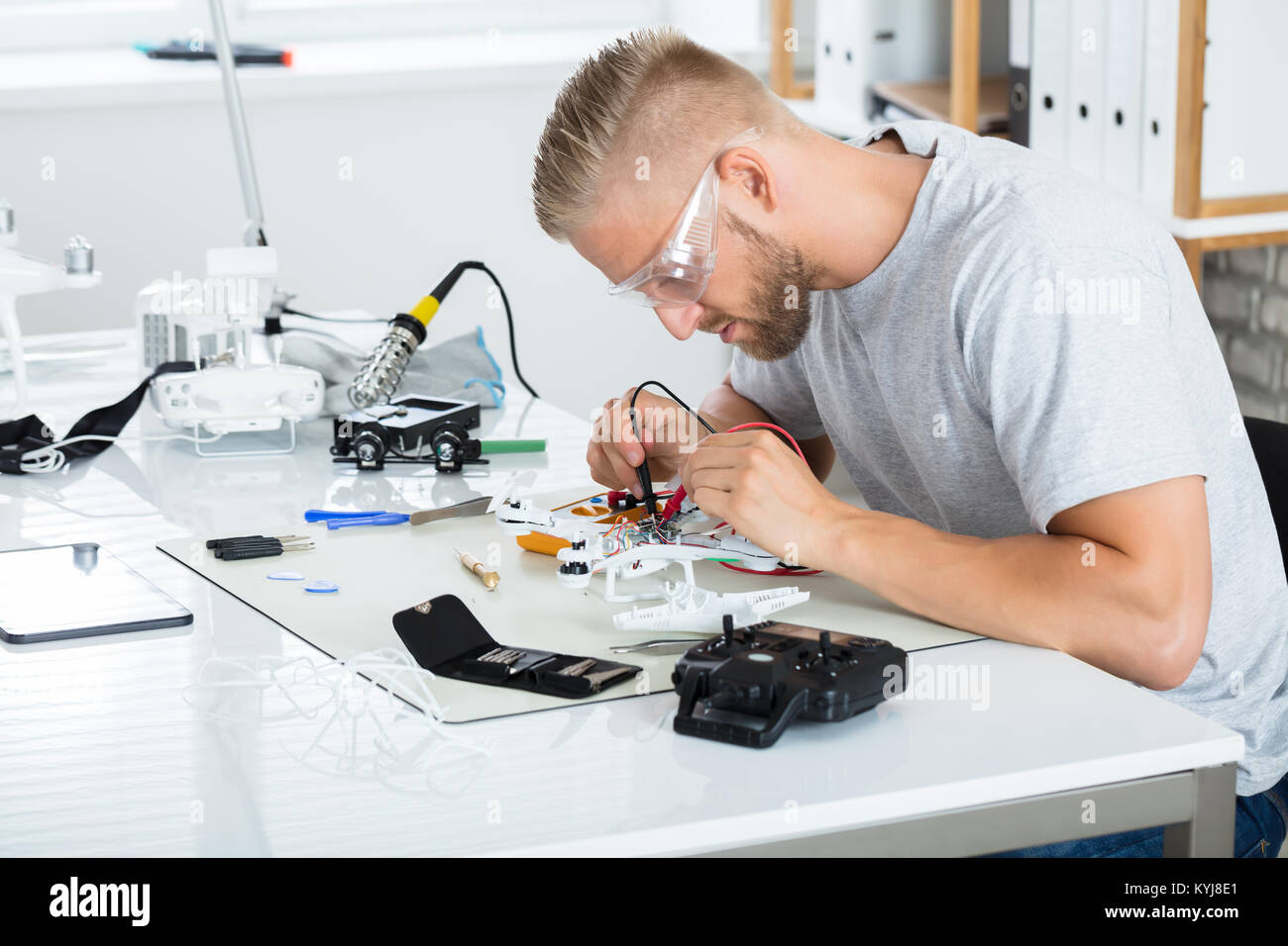 Close-up Of A Man Testing Electric Current Of Disassembled Drone Using ...