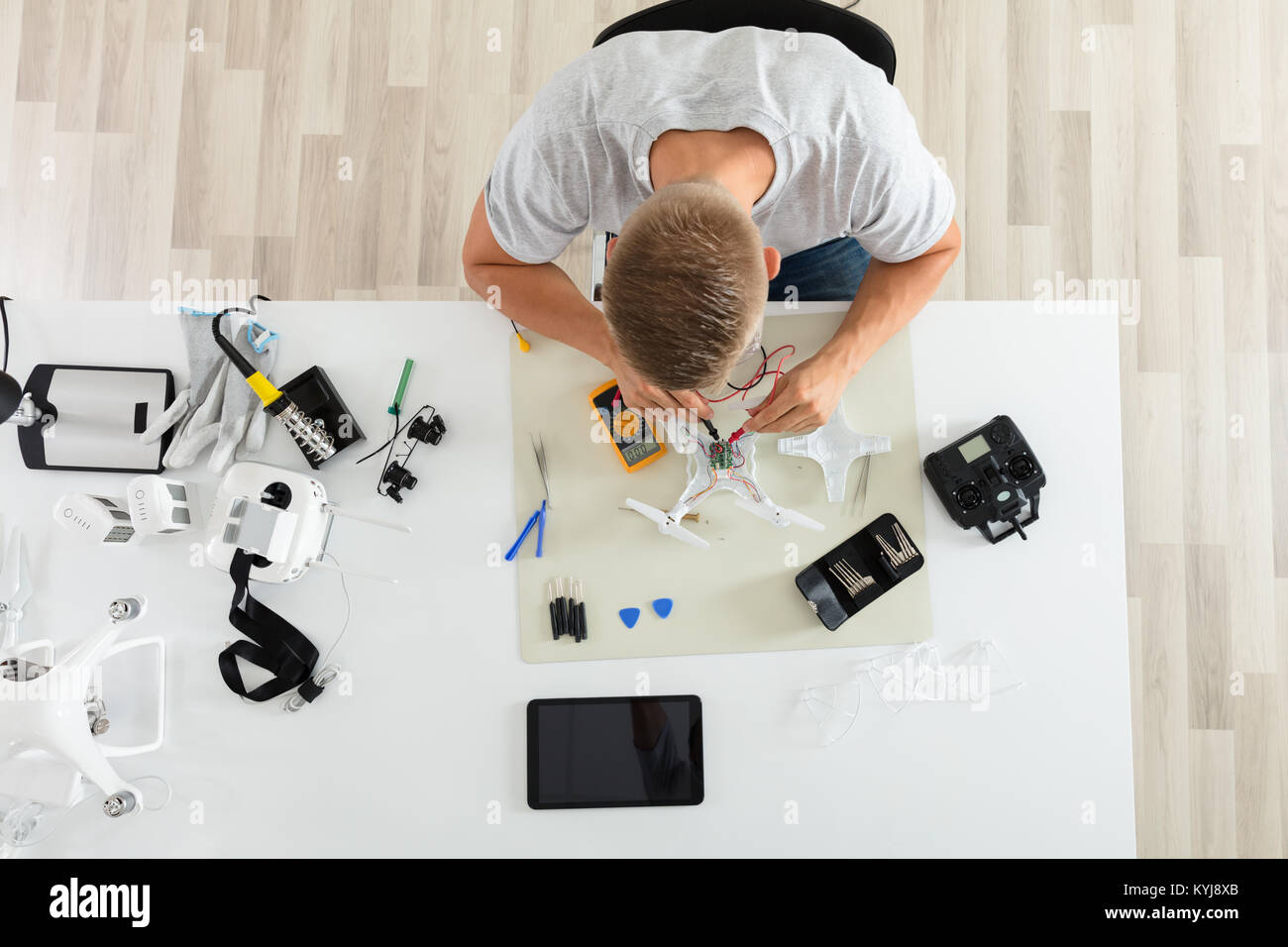 Close-up Of A Man Testing Electric Current Of Disassembled Drone Using ...
