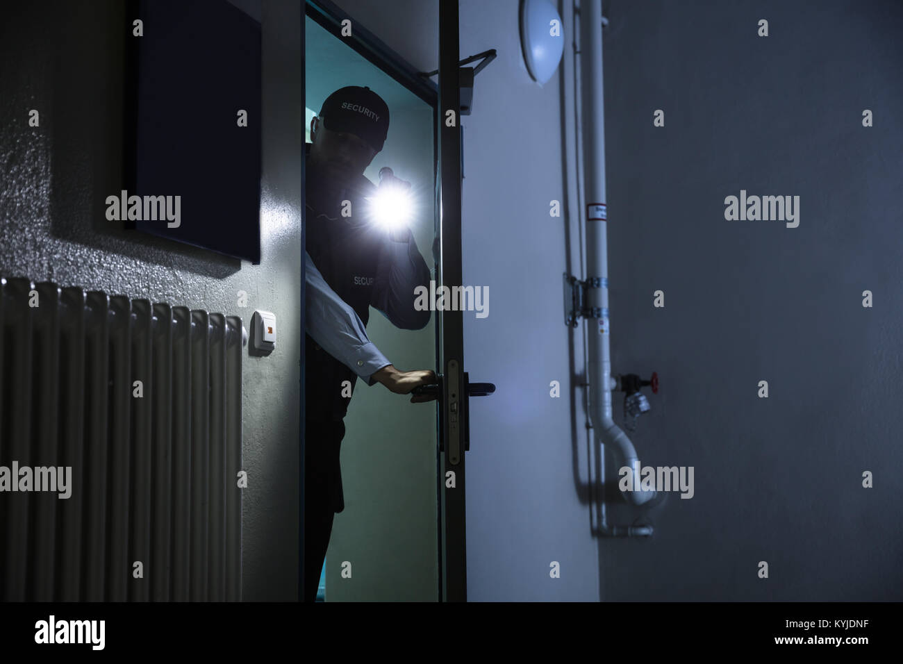 Male Security Guard Searching With Flashlight At Industry Stock Photo ...