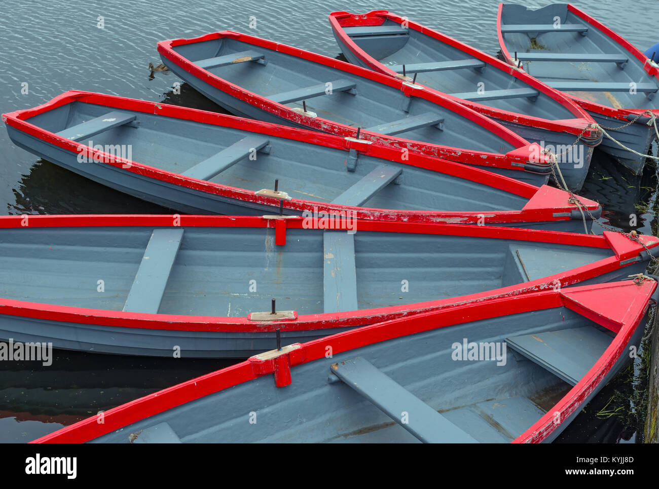 a group of red and grey rowboats Stock Photo - Alamy