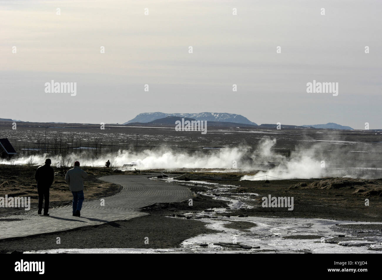 Visitors strolling along beside roped-off area in the geothermal field ...