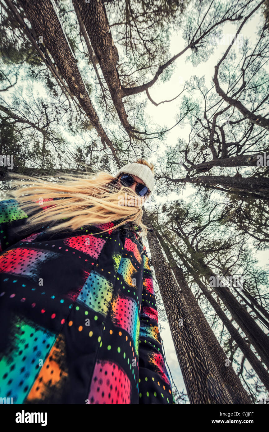Perspective photo of a teen girl standing in the forest among giant ...