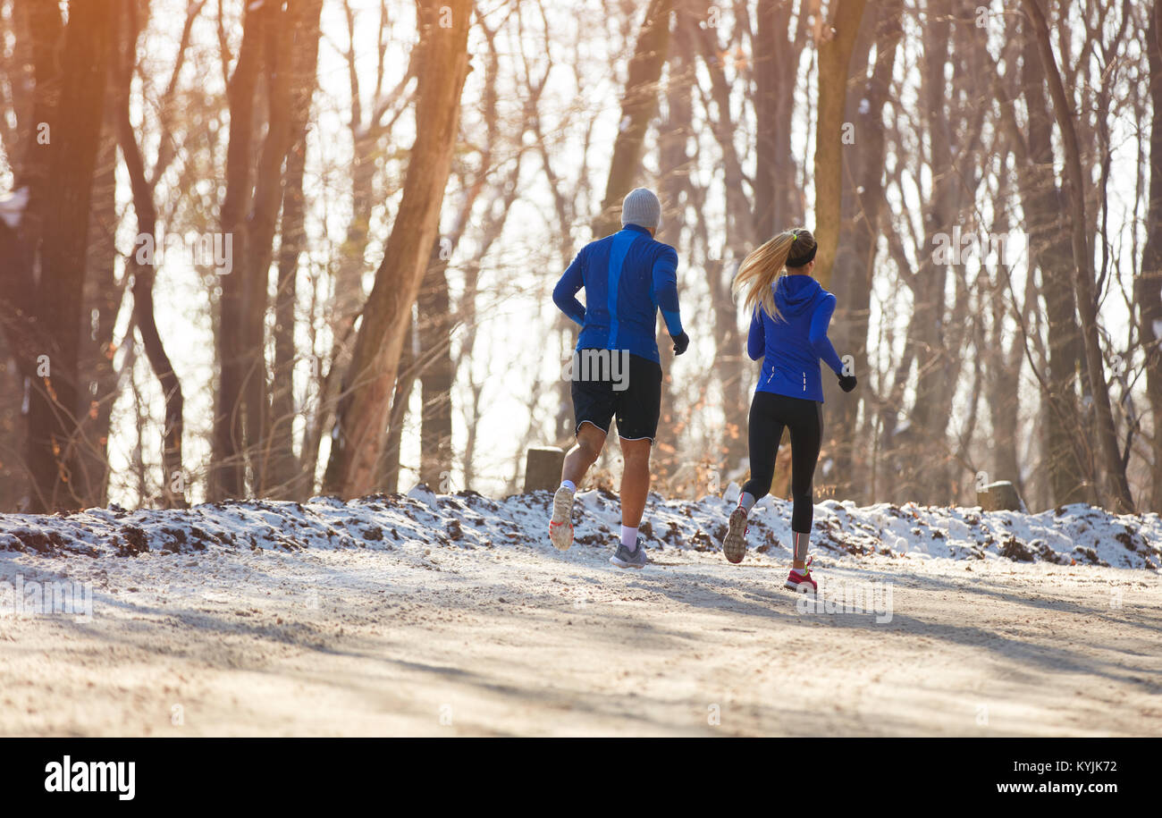 Male and female running outdoor, back view Stock Photo - Alamy